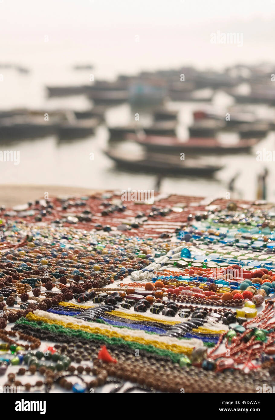 Prayer beads and other religious objects at a market stall, Varanasi ...