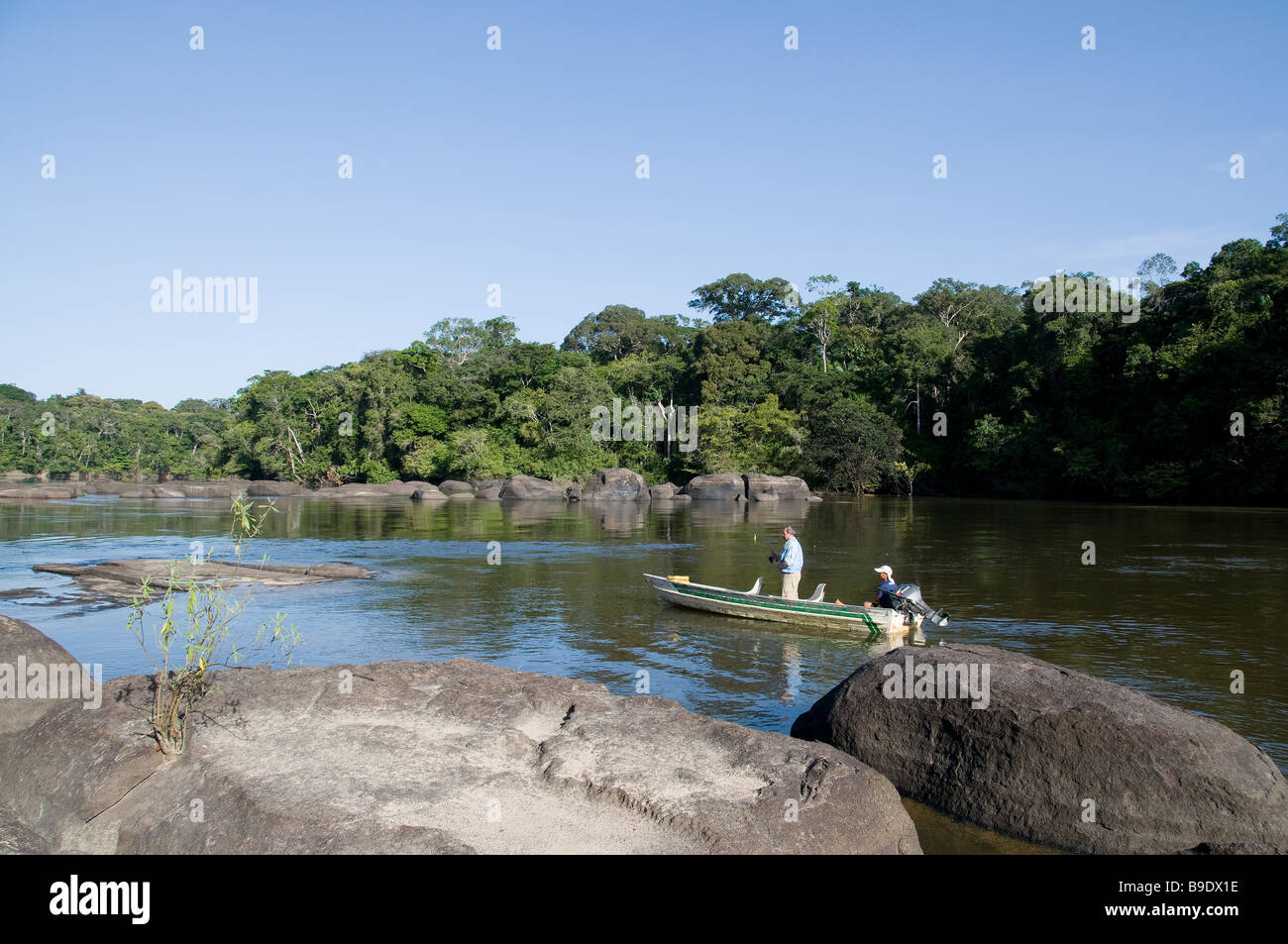 An angler fishes a lure for peacock, piranha, payara and trairao in a ...