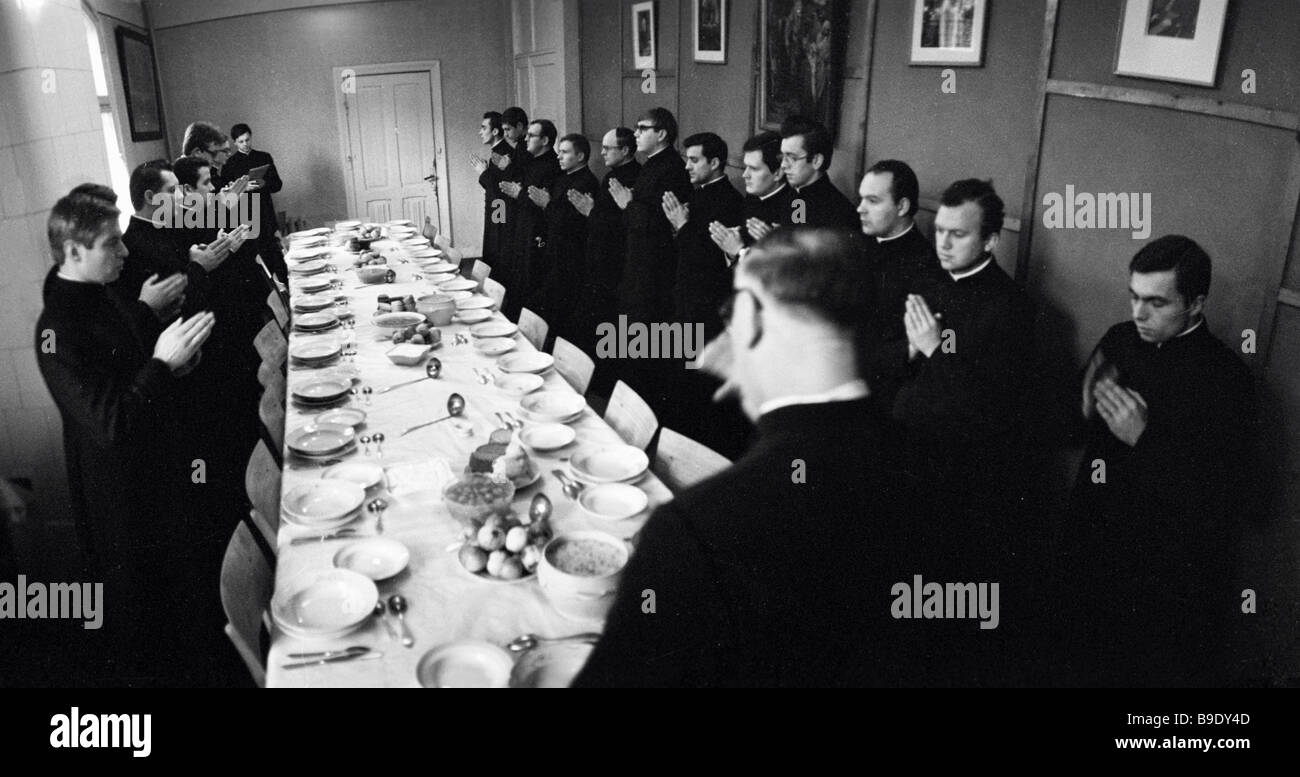 Students of a Catholic theological seminary praying before a meal in ...