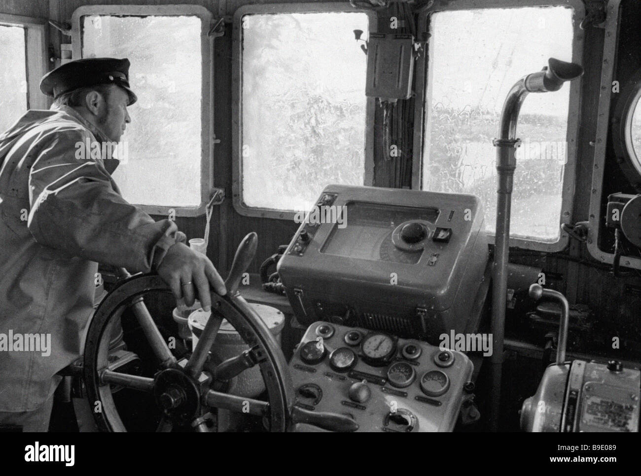 The launch s captain at the wheel Stock Photo - Alamy