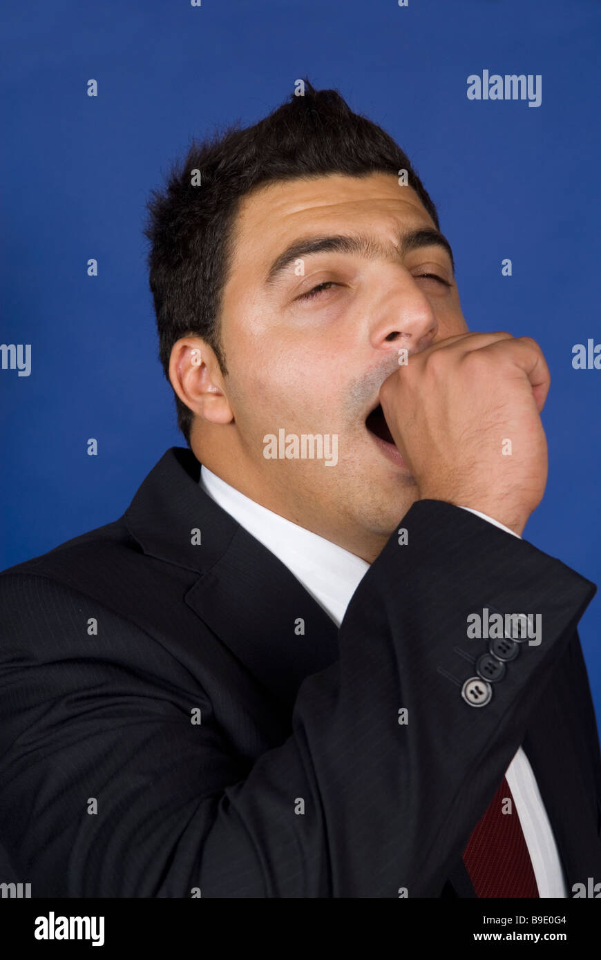 Business man yawning Stock Photo - Alamy