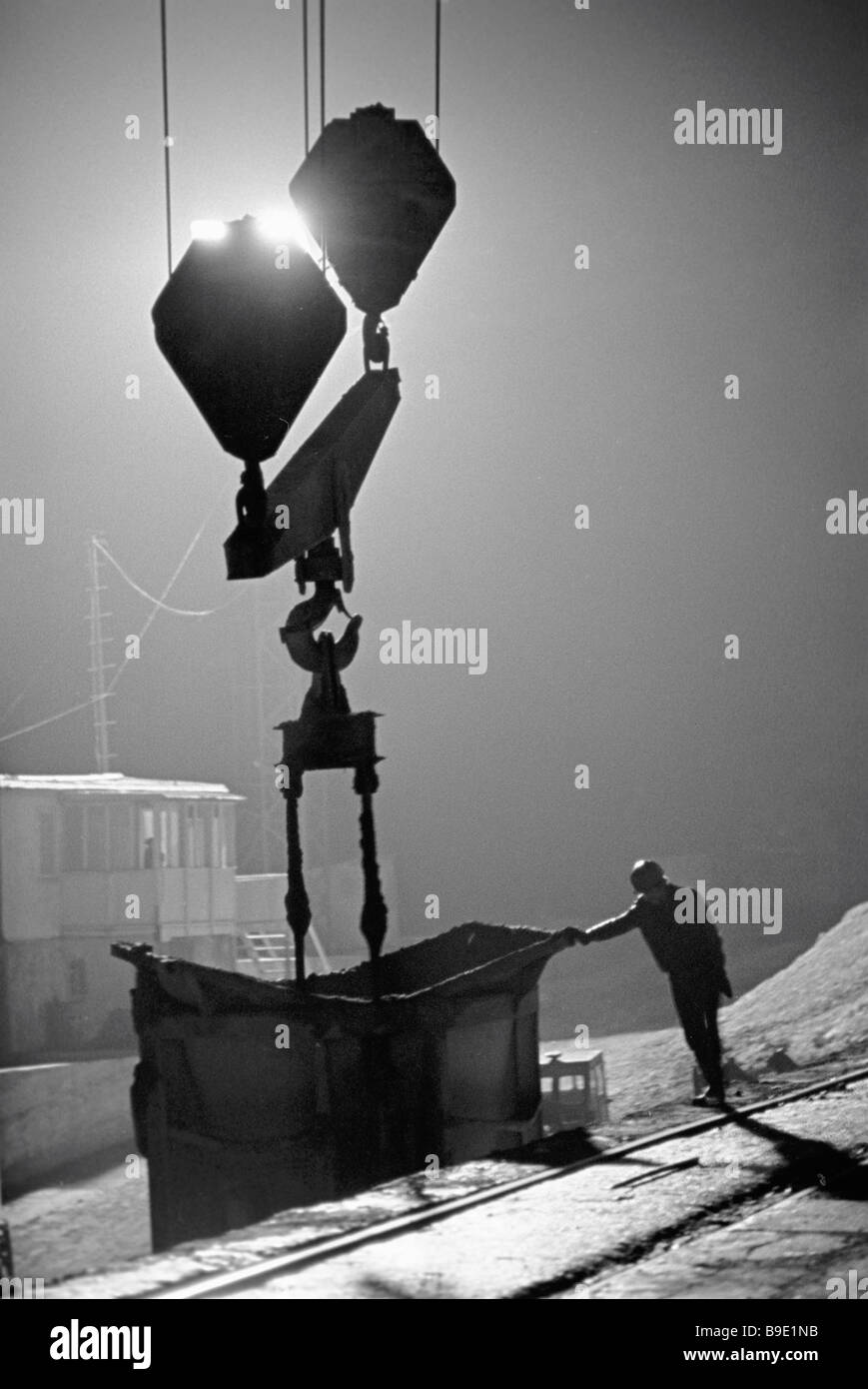 A cable crane delivers a bucket with slurry to the dam body Inguri HPP ...