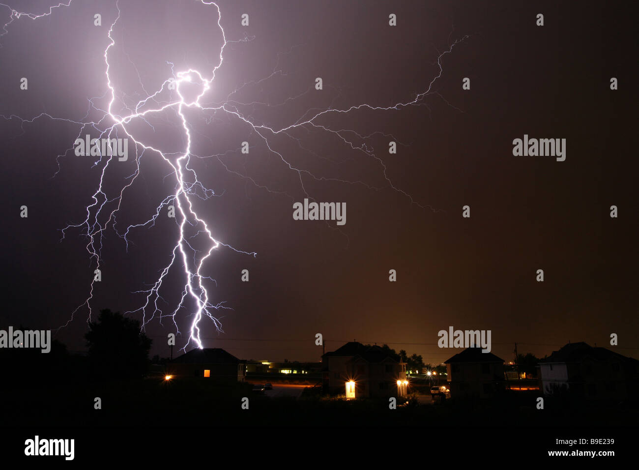 huge lightning bolt hitting in a city near houses Stock Photo - Alamy