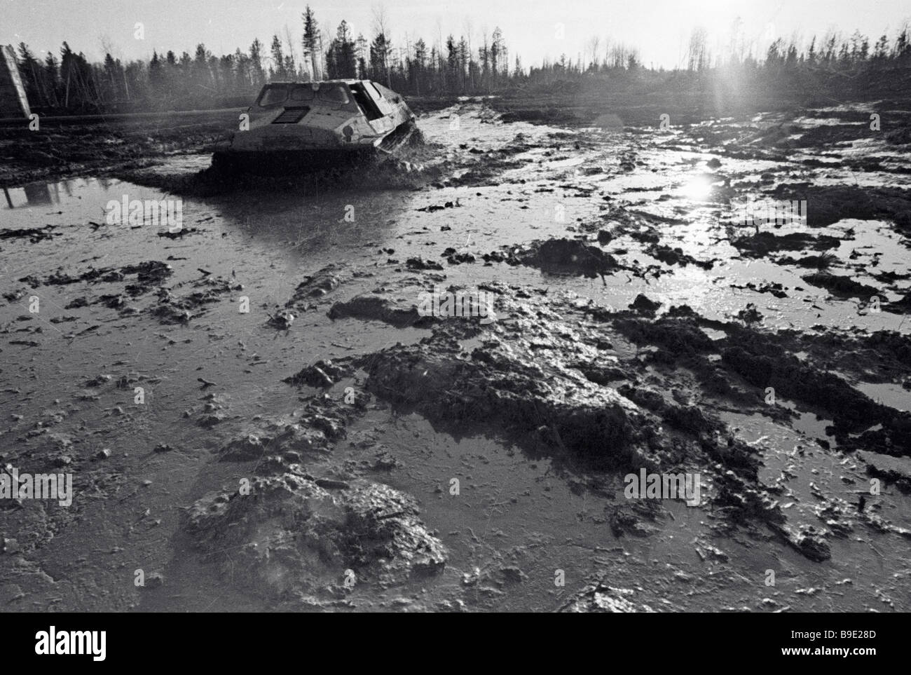 A crawler tractor moving across a bog Agansk oil field Stock Photo - Alamy