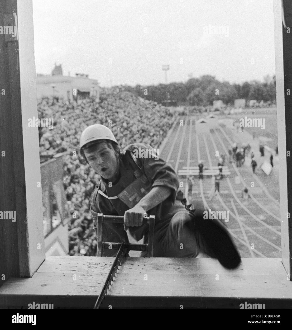 A fire brigade member climbing a ladder Stock Photo - Alamy