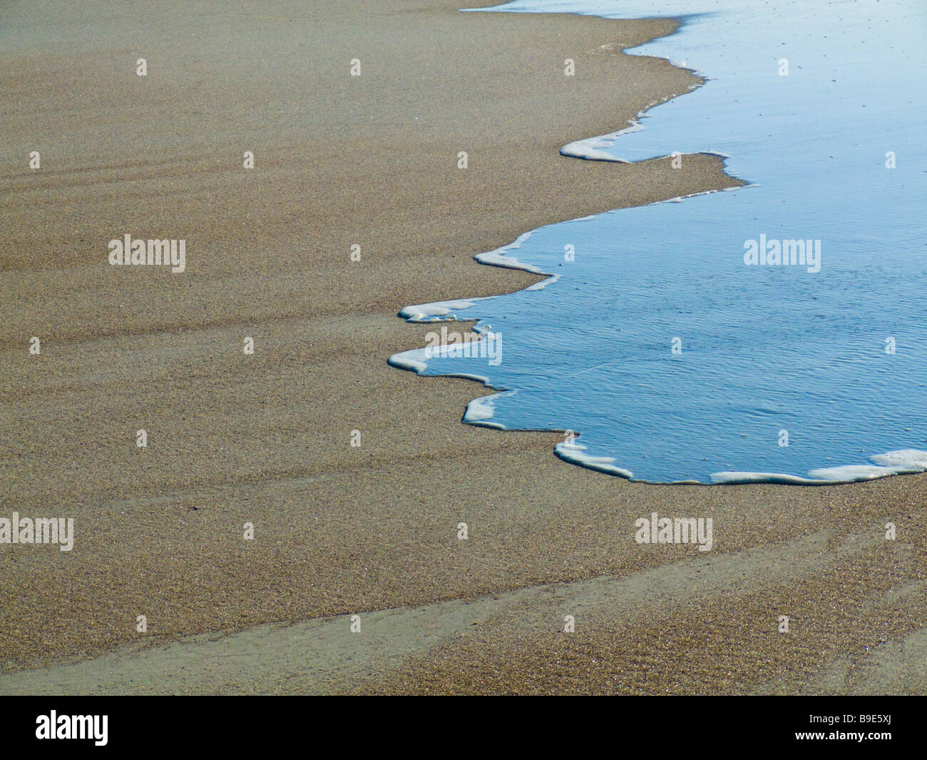 water washing up on beach Stock Photo - Alamy
