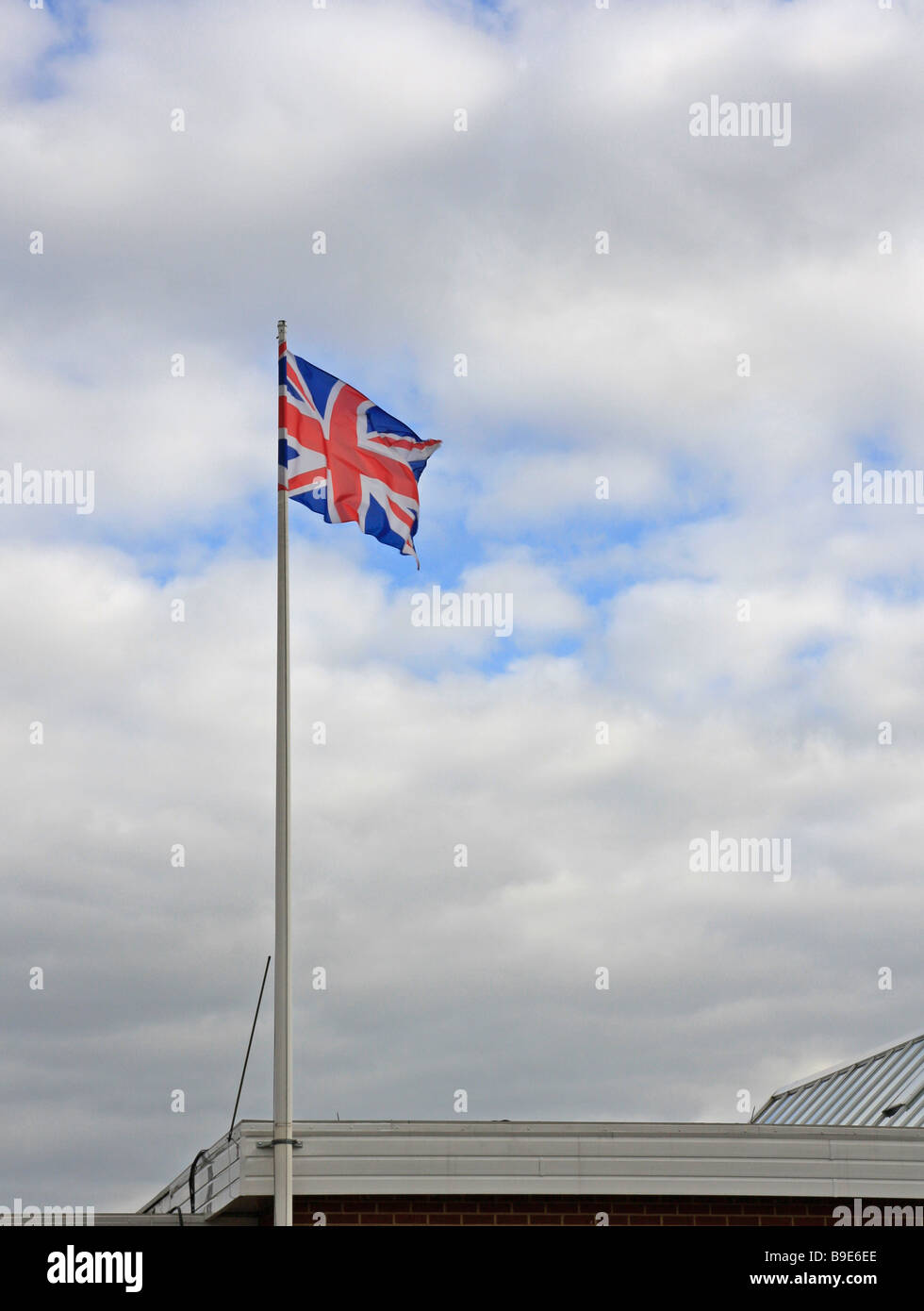 The Union Jack flag flying from a building rooftop Stock Photo - Alamy
