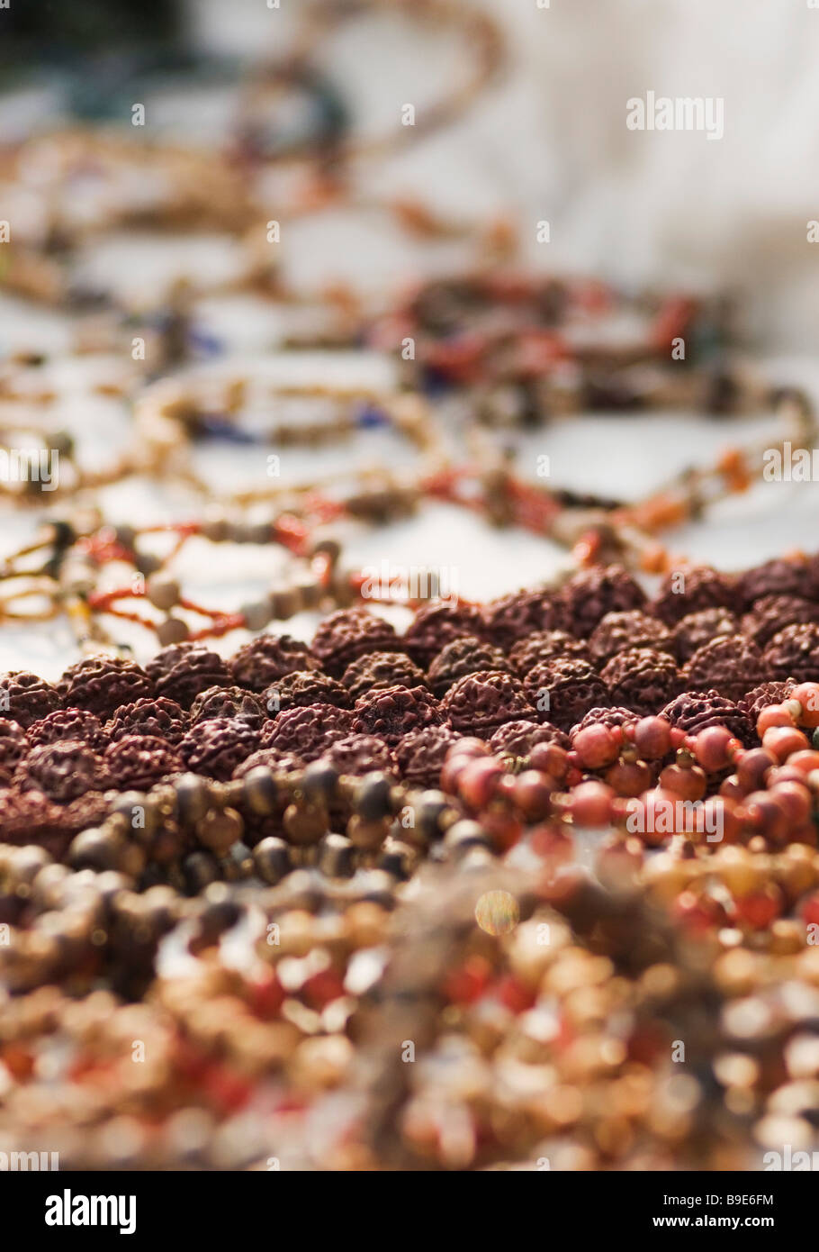 Prayer beads and other religious objects at a market stall, Varanasi ...