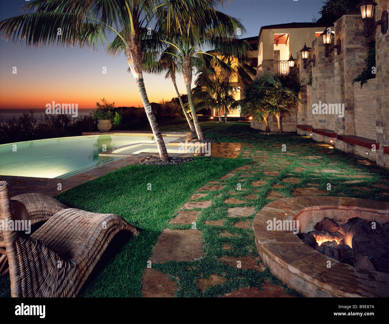 Backyard of modern home with pool at sunset Stock Photo - Alamy