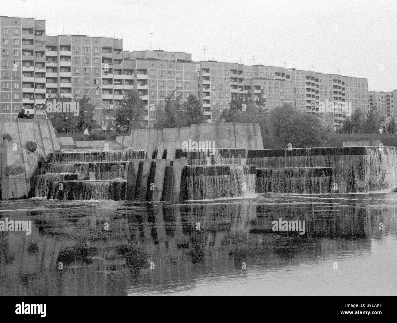 Man made cascades on a lake in front of a residential area Stock Photo ...