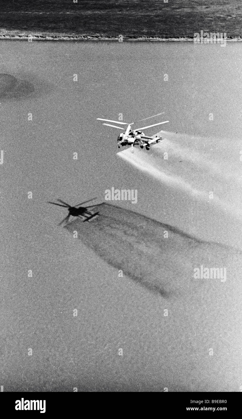 Kamov Ka 26 Hoodlum helicopter sprays disinfectants on fish ponds Stock ...