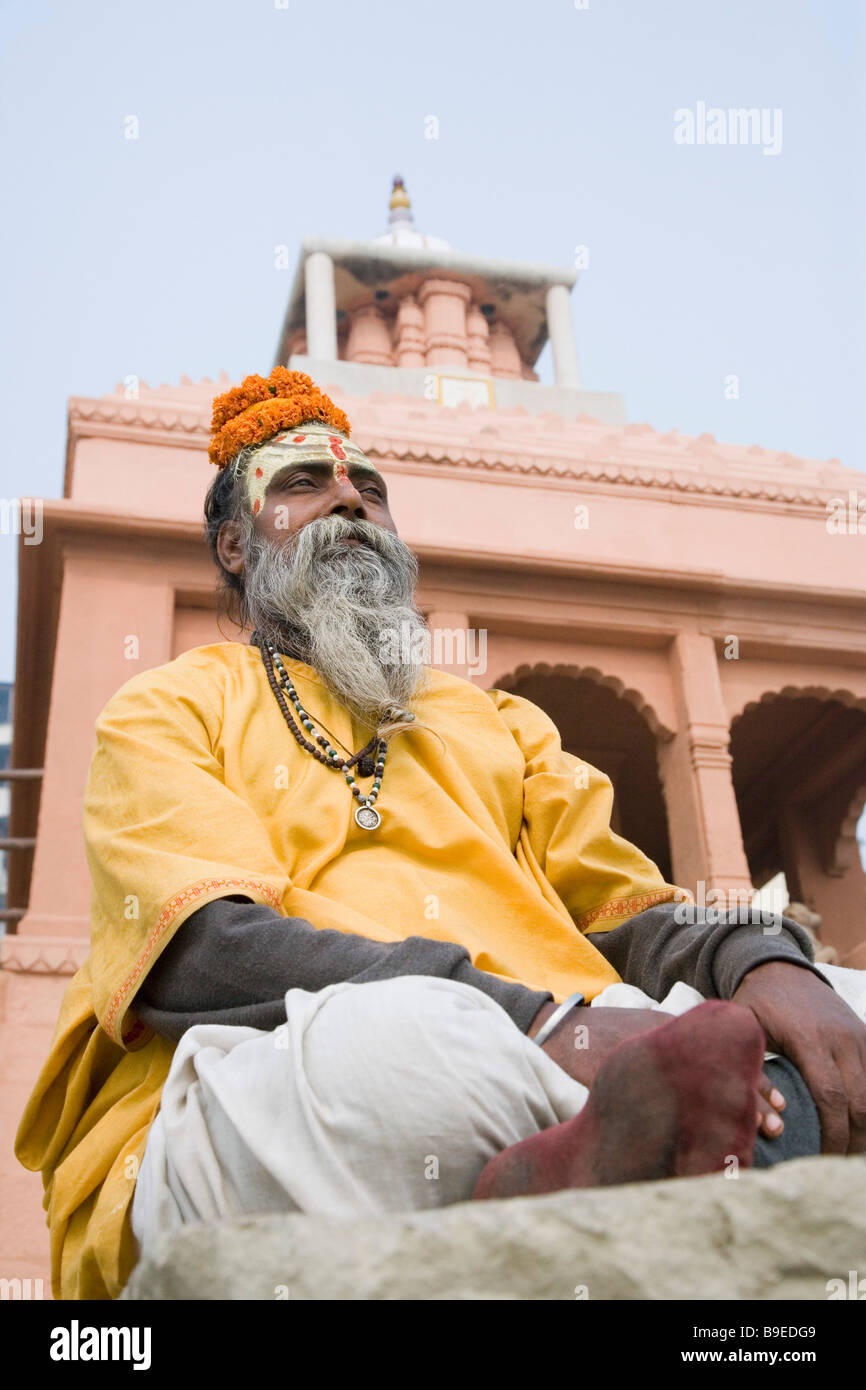 Sadhu sitting and praying in front of a temple, Varanasi, Uttar Pradesh ...