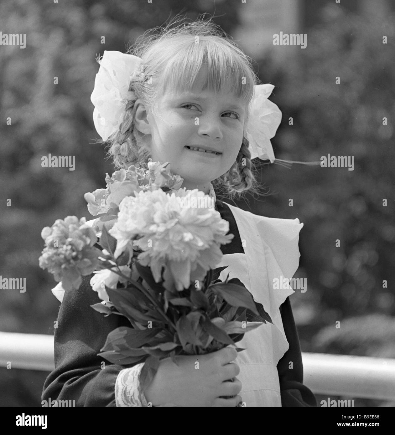 A first grader going to school with a bunch of flowers Stock Photo - Alamy