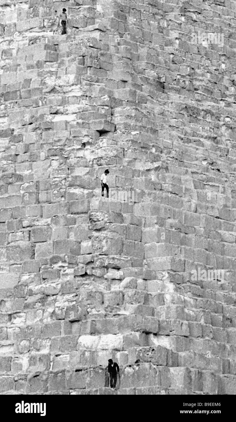 Tourists climb the Pyramid of Cheops in Giza Stock Photo - Alamy