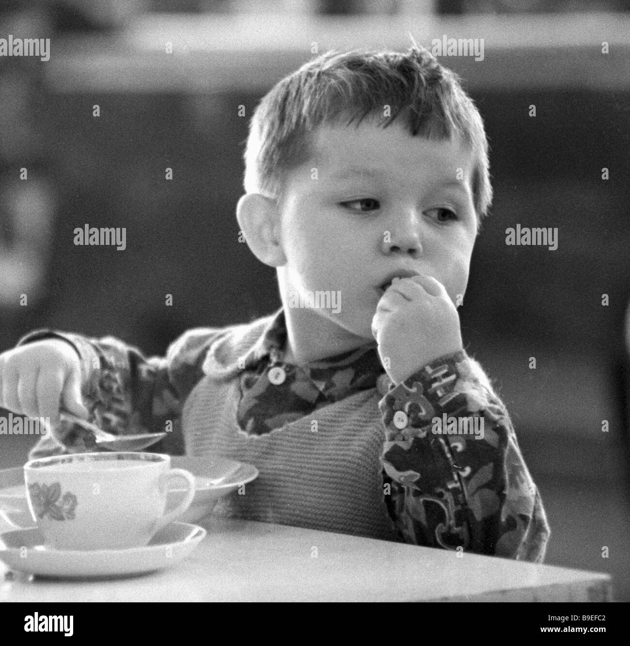 A boy having breakfast in the kindergarten Stock Photo - Alamy