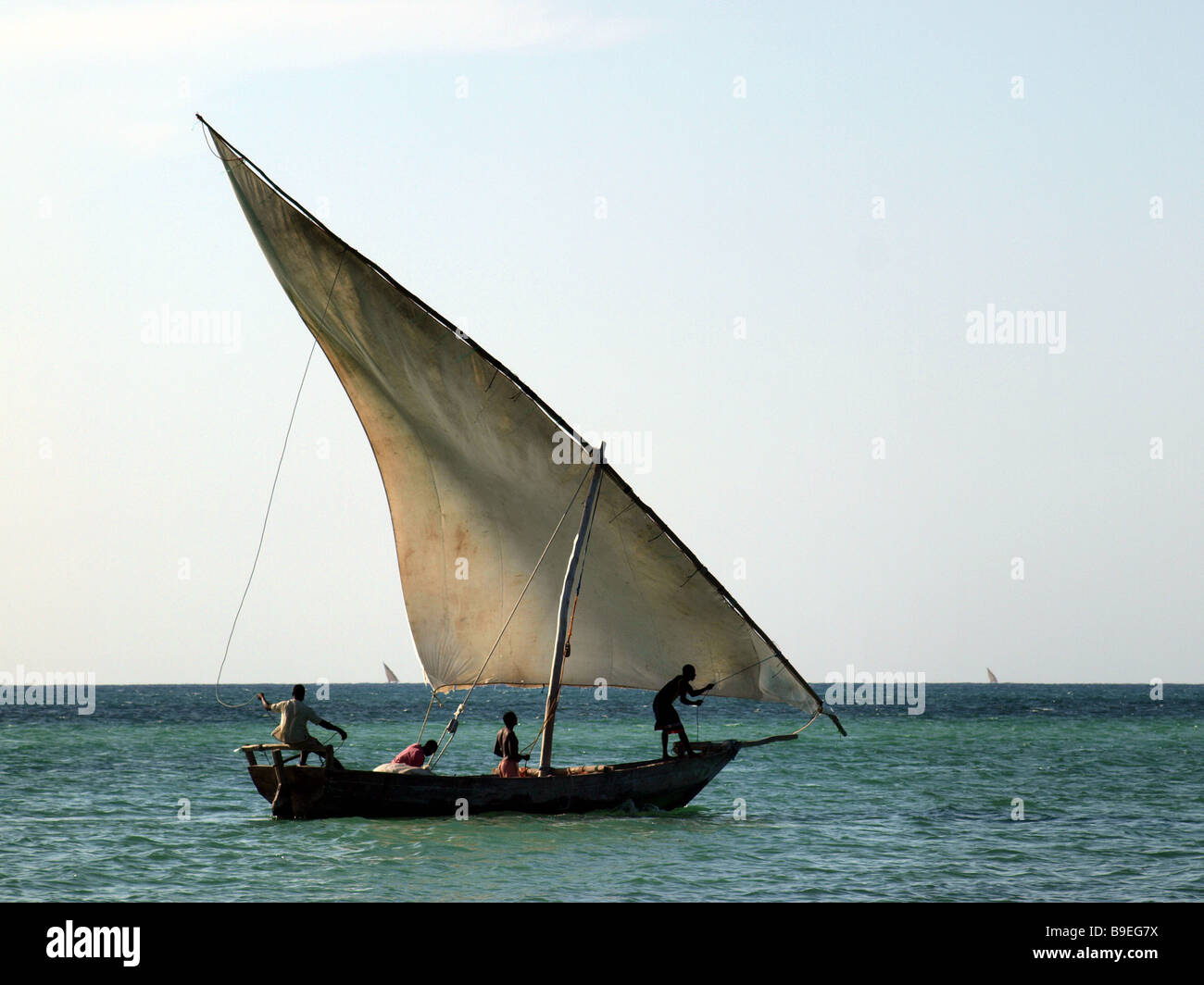 local fishermen setting sail in outrigger fishing boat or ngalawa ...