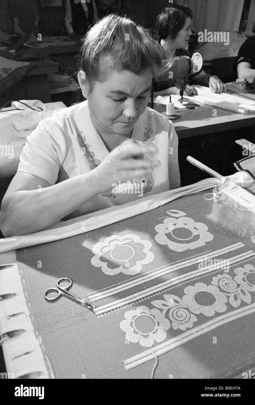 Embroideress working in the stitch and embroidery factory atelier Stock ...