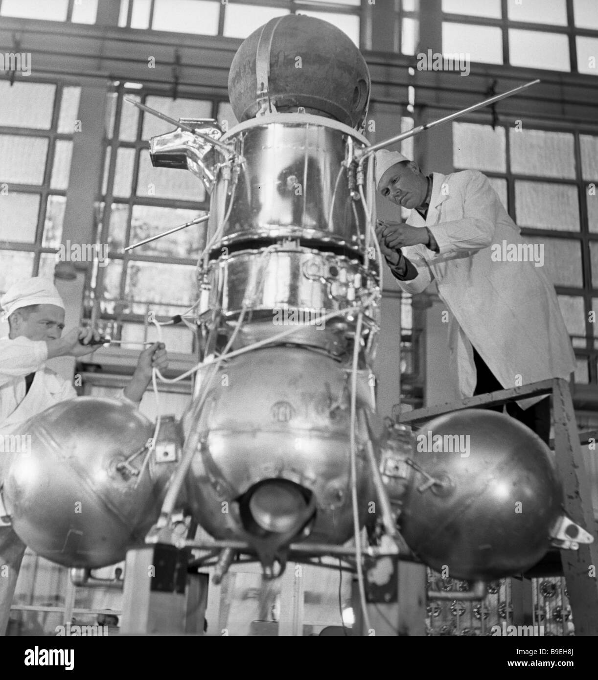 An assembly and test team checks the Luna 16 automated lunar station ...