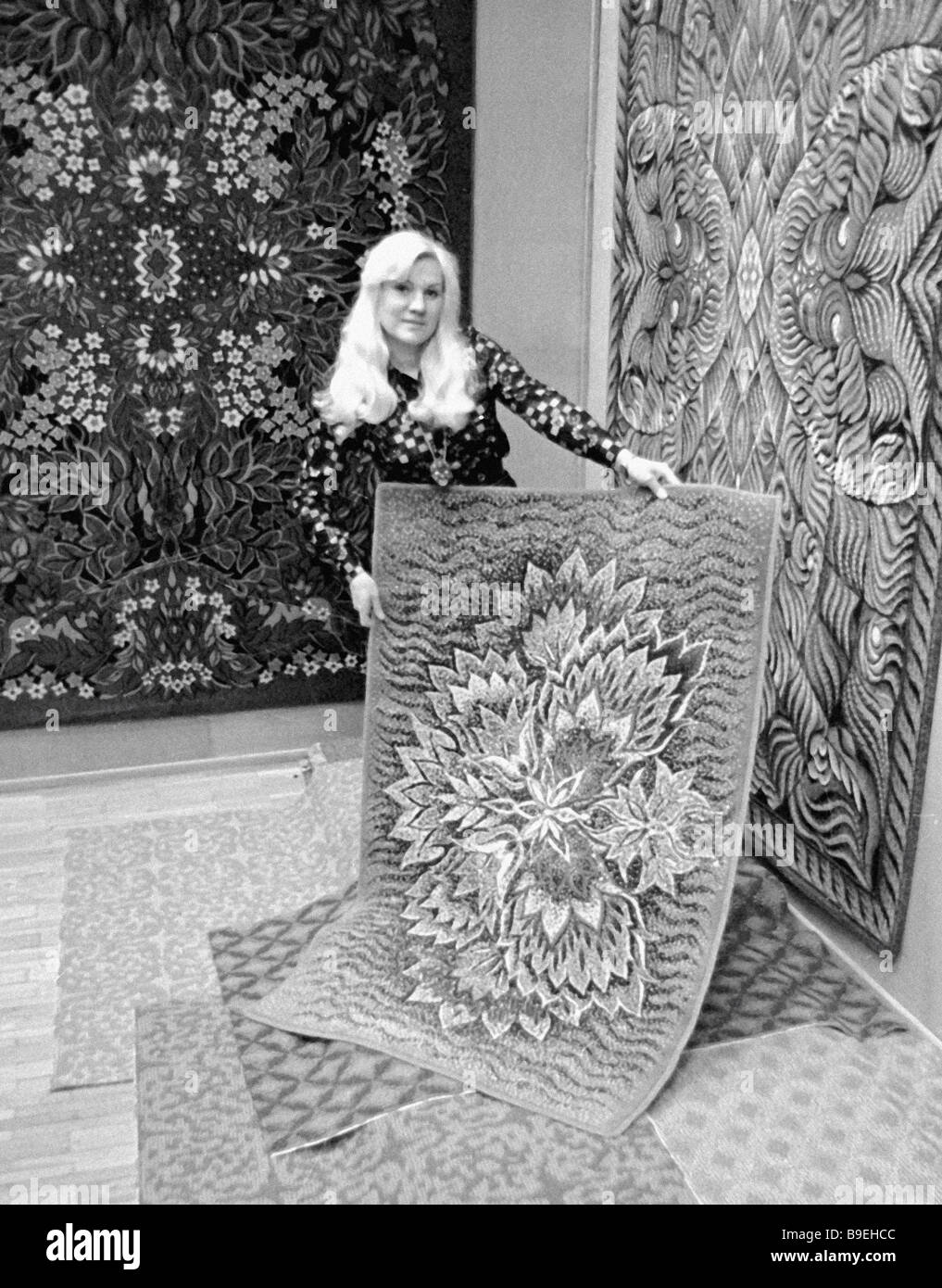 A girl demonstrating rugs woven by Lithuanian makers Stock Photo - Alamy