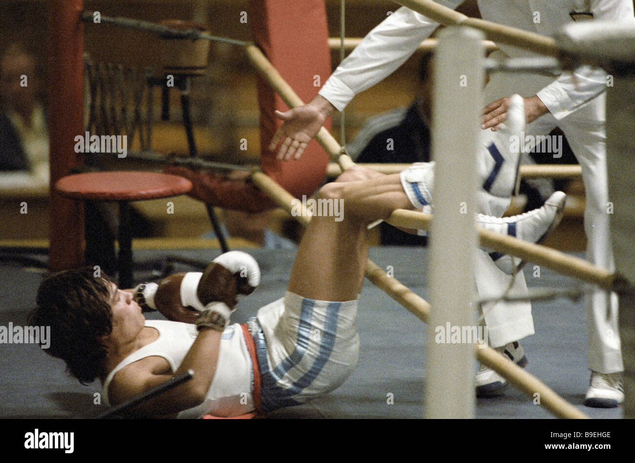 A boxer falls behind the ropes during the match at the 7th summer ...