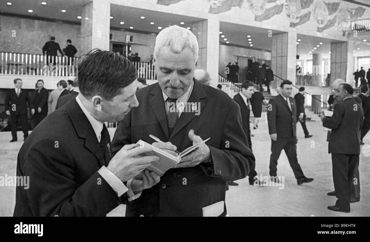 Writer Konstantin Simonov right gives an autograph in the recess of the ...