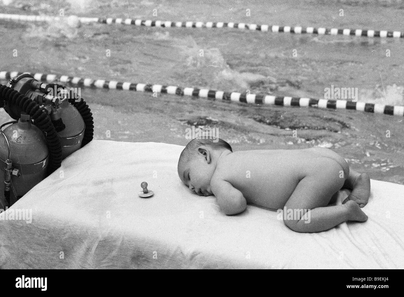 Baby sleeping after water pool swimming Stock Photo - Alamy