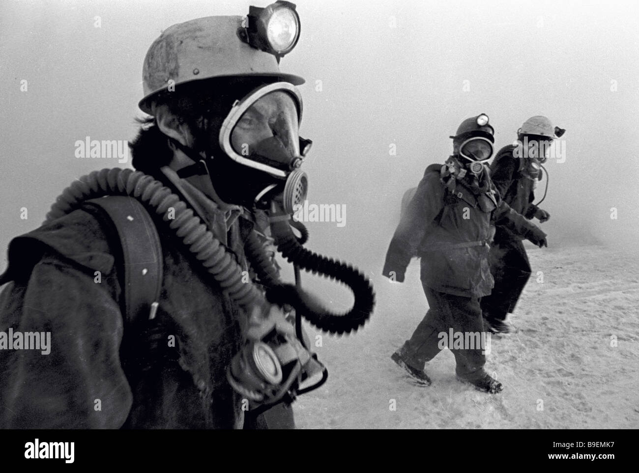 Miners in safety masks that protect in gaseous atmosphere and permit to ...