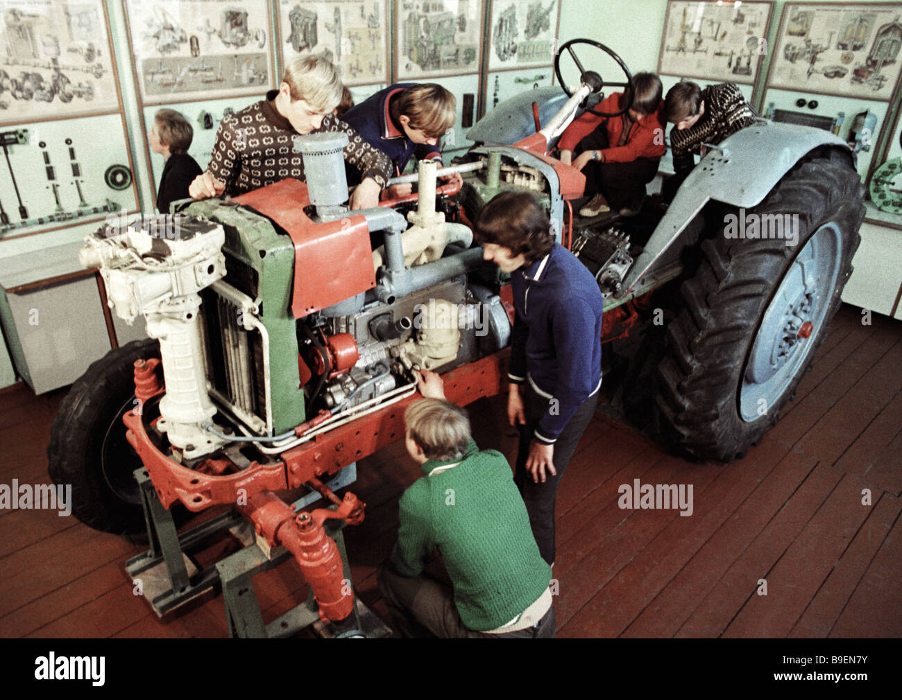 Schoolchildren study structure of a tractor at the manual training ...