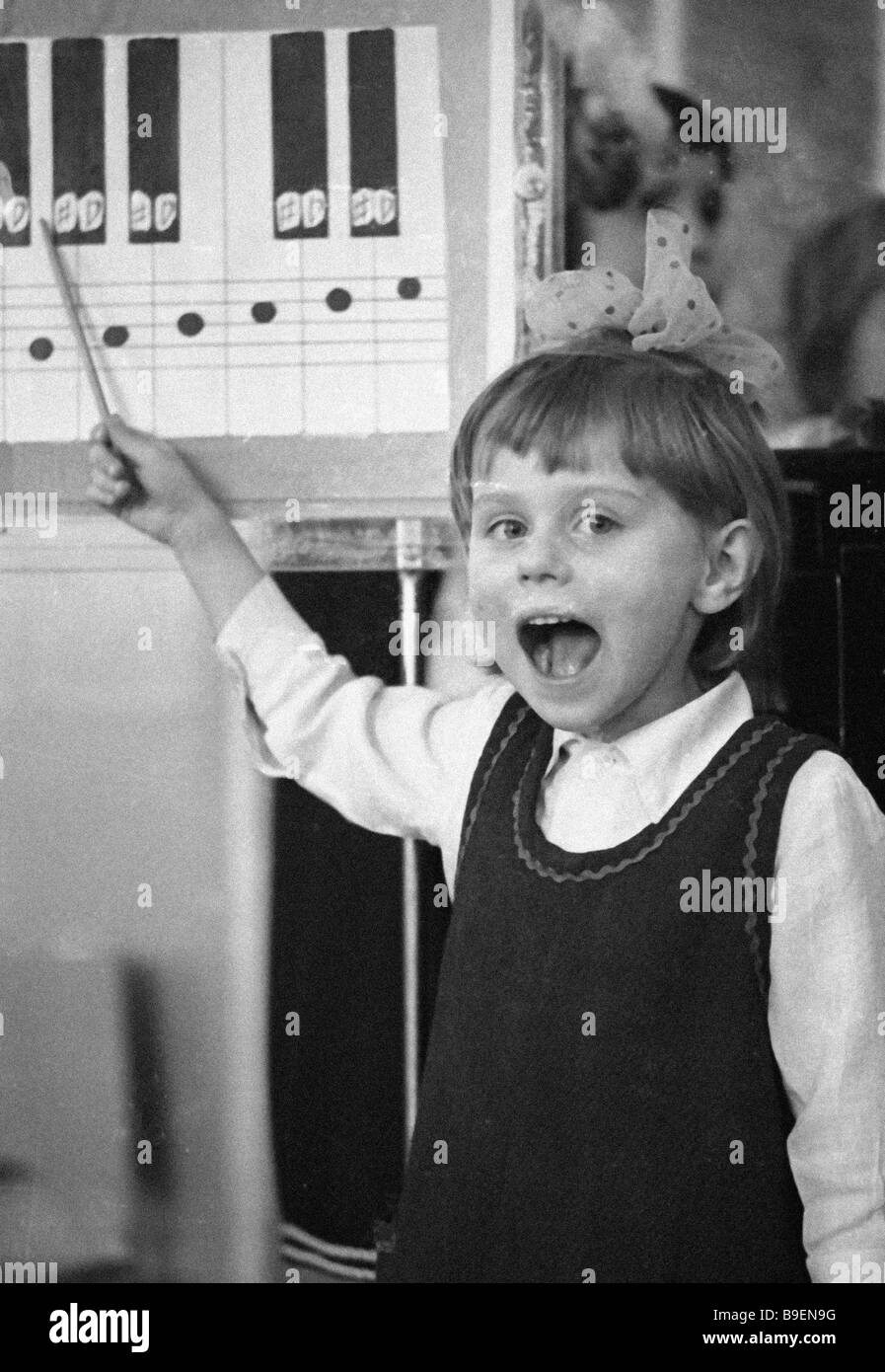 A kindergarten girl sings in music class Stock Photo - Alamy