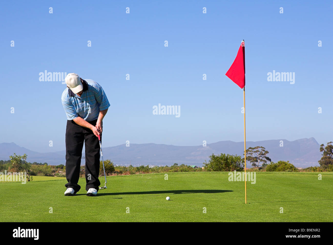 Man playing golf Stock Photo - Alamy