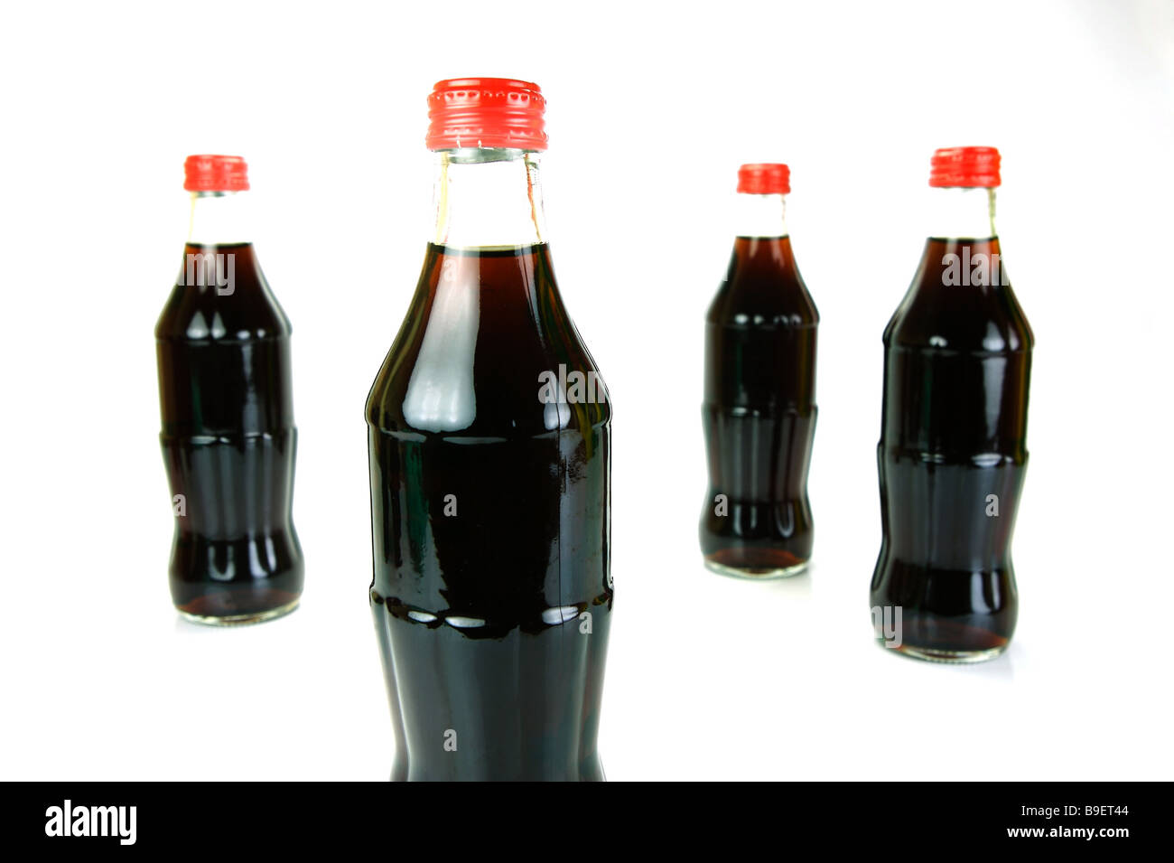 Cola bottles isolated against a white background Stock Photo - Alamy