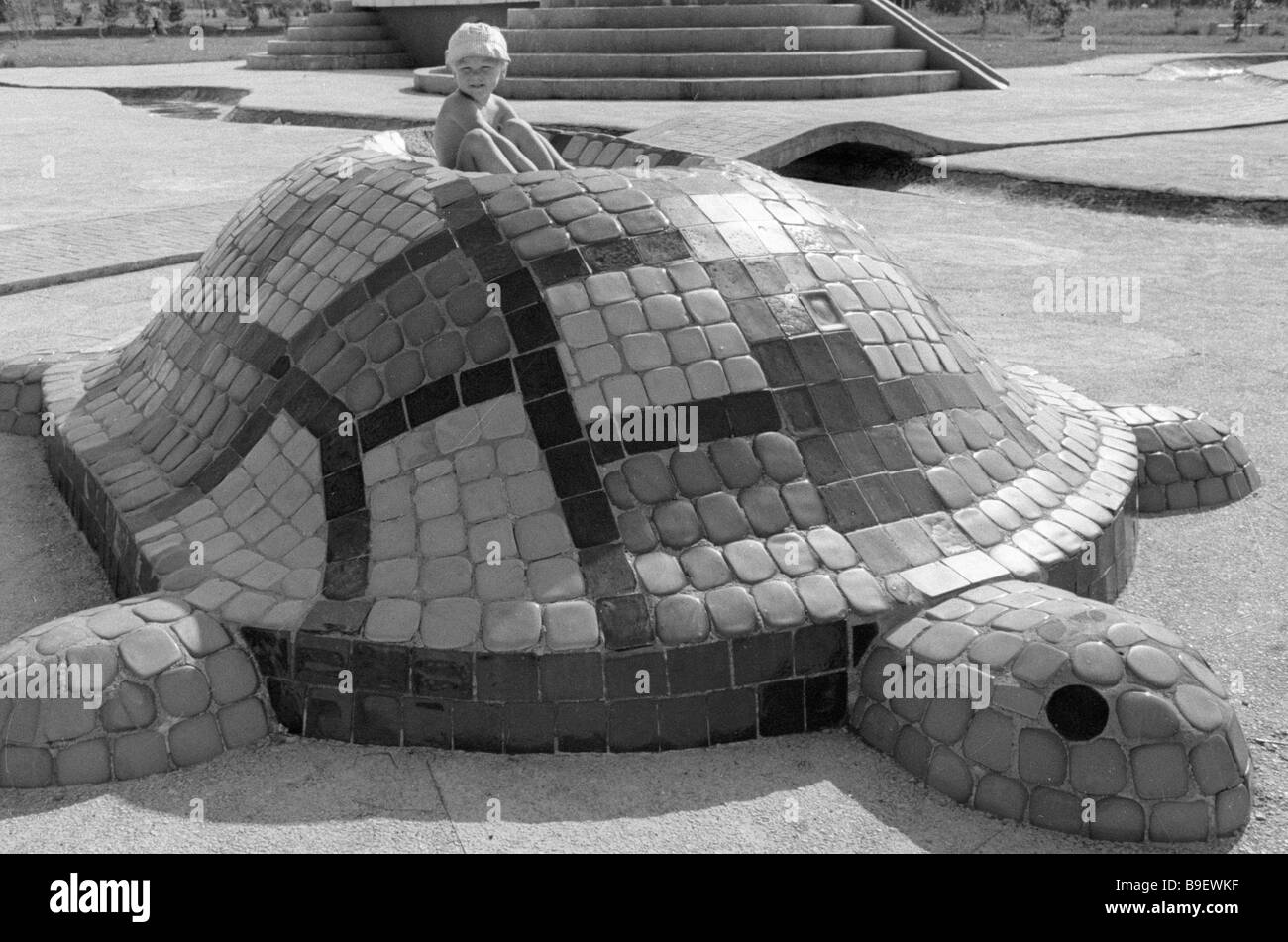 A boy playing with a figure of a fairytale turtle on children s ...
