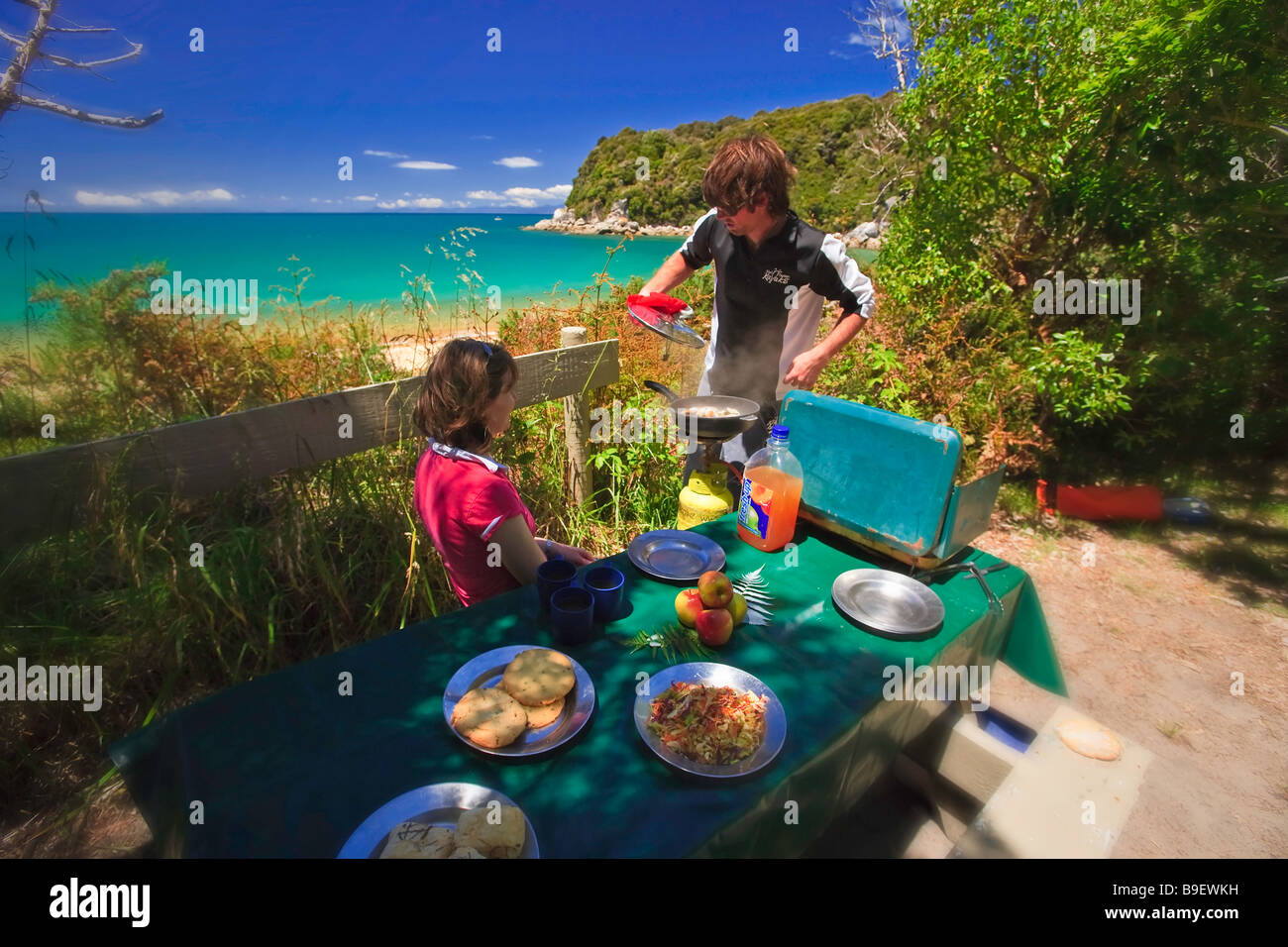Kayak guide cooking lunch at Te Pukatea Bay,Abel Tasman National Park ...