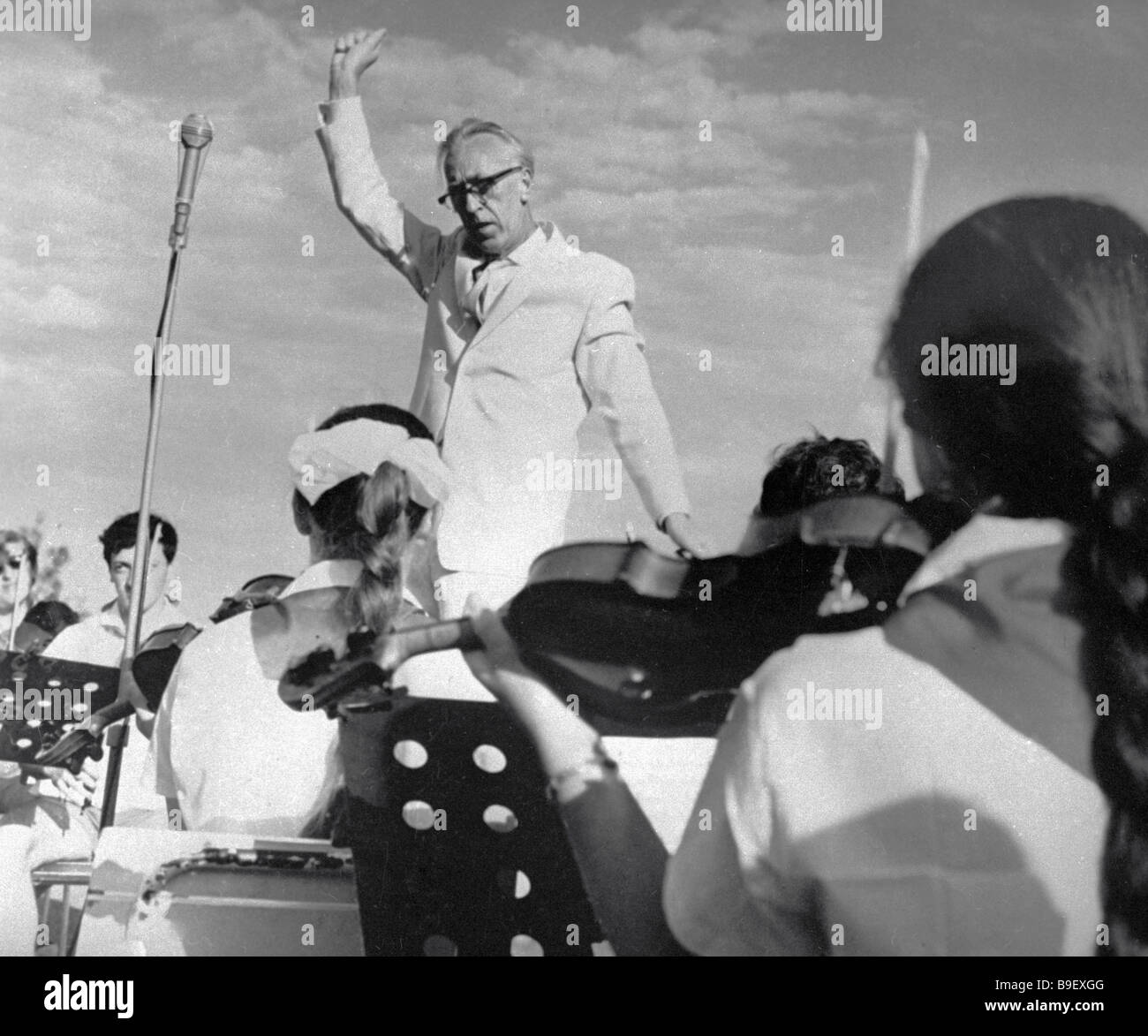 Composer Dmitry Kabalevsky standing conducting the orchestra of ARTEK ...