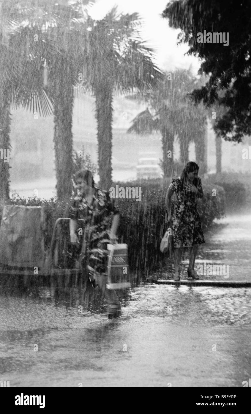 Girls fleeing the rain Stock Photo - Alamy