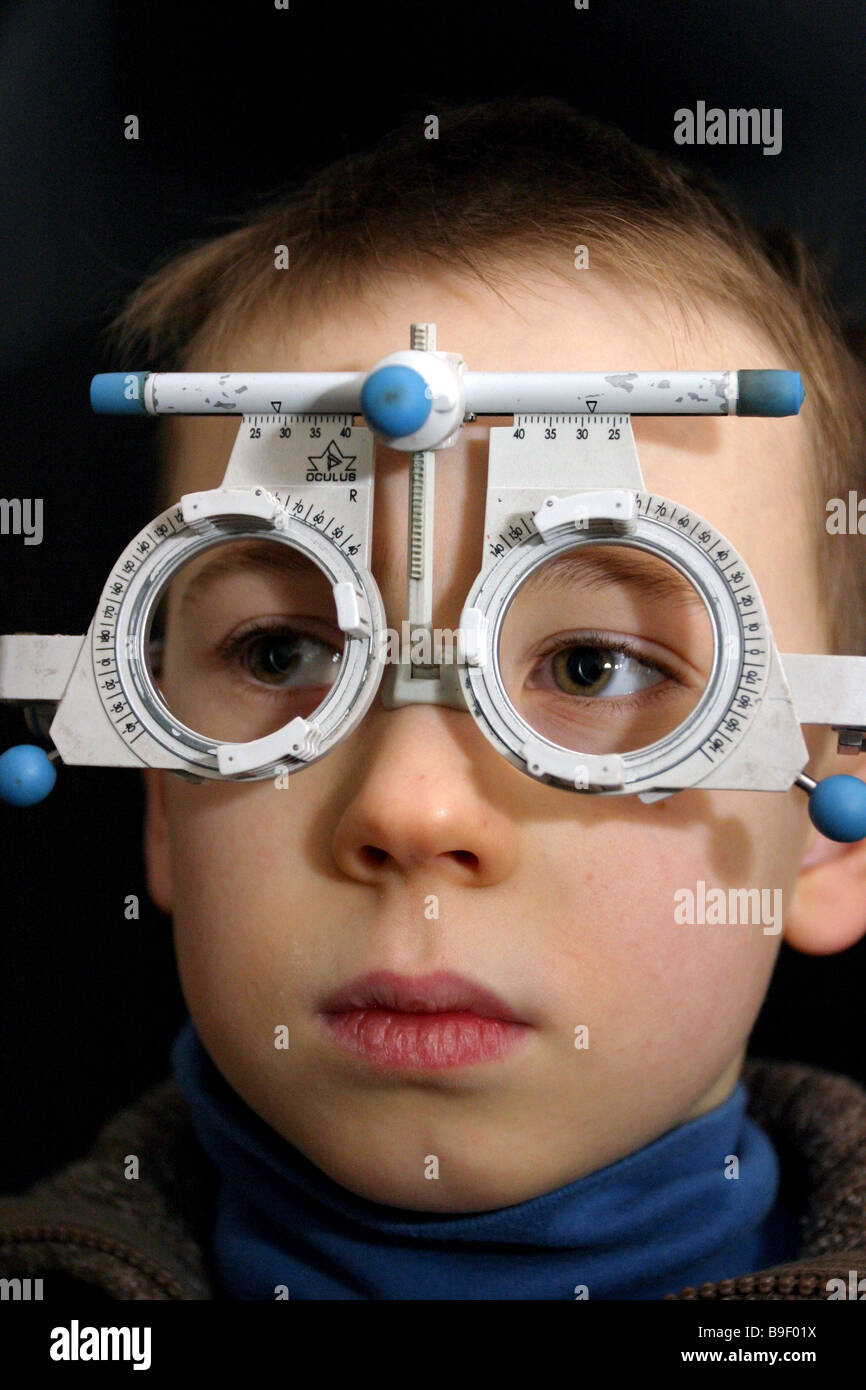 Young child having eyes tested with optical goggles being tested Stock ...