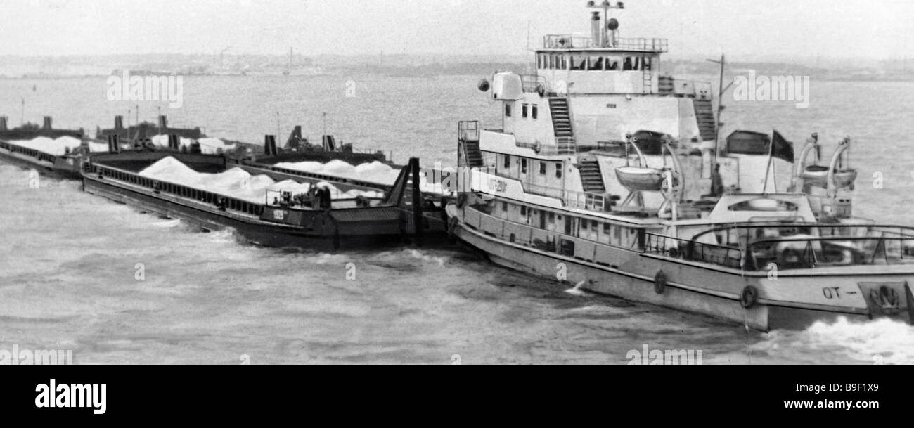 A pusher barge train casting off from the pier Stock Photo - Alamy