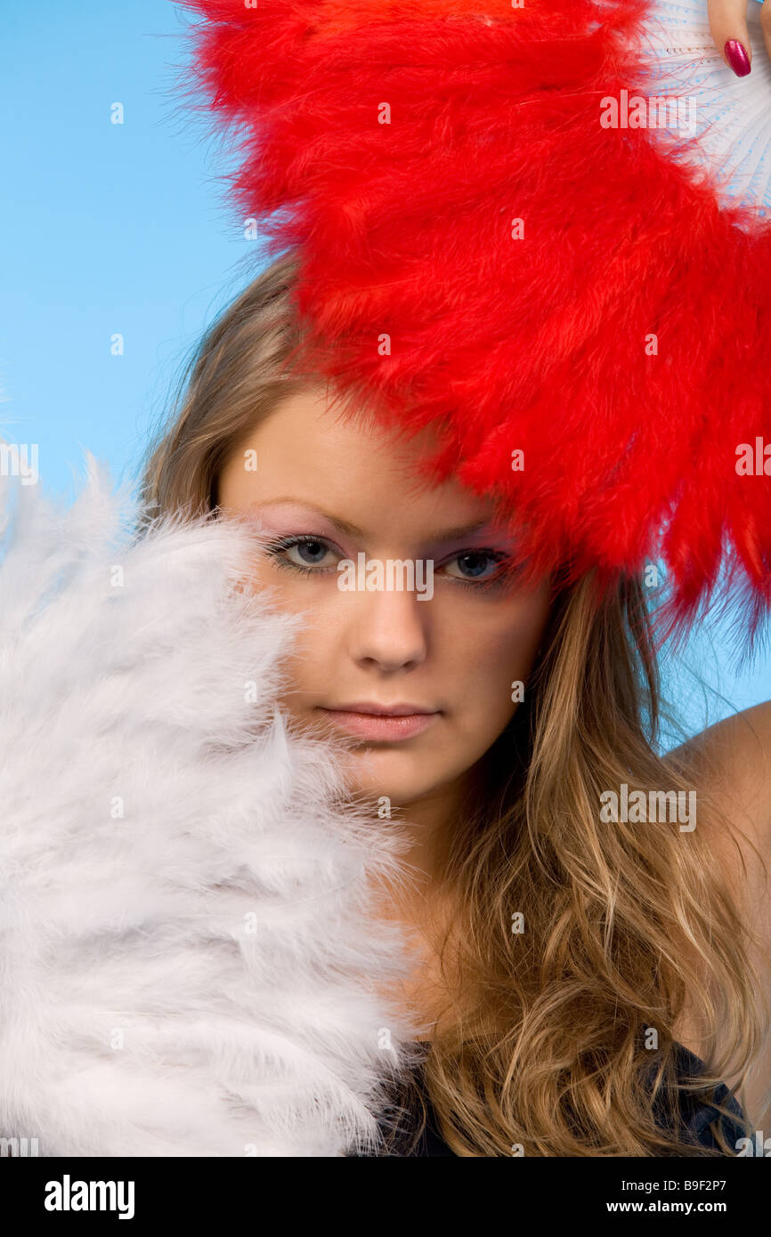 beautiful woman with two fans on a blue background Stock Photo - Alamy