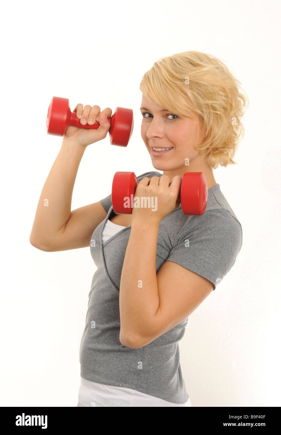 young woman doing exercise with two red dumbbell Stock Photo - Alamy