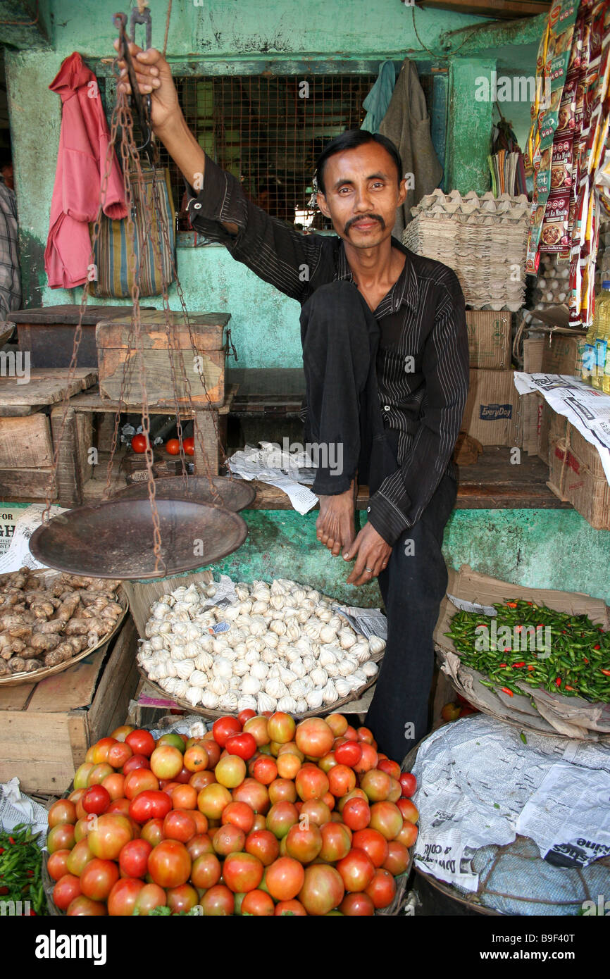 Vegetable Seller Holding a Pair Of Scales on his Market Stall, Diphu ...