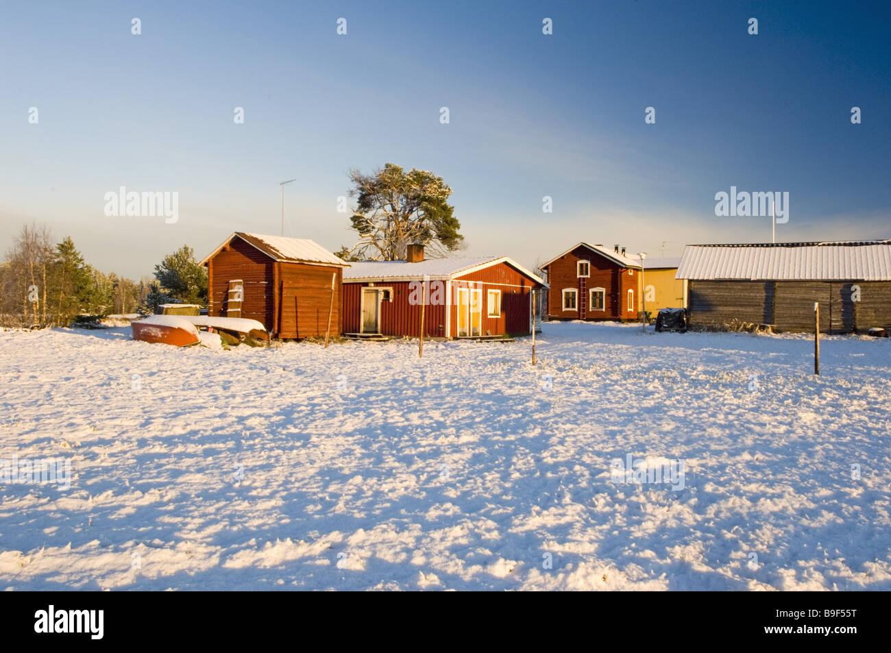 Finland houses alps red snow Stock Photo - Alamy
