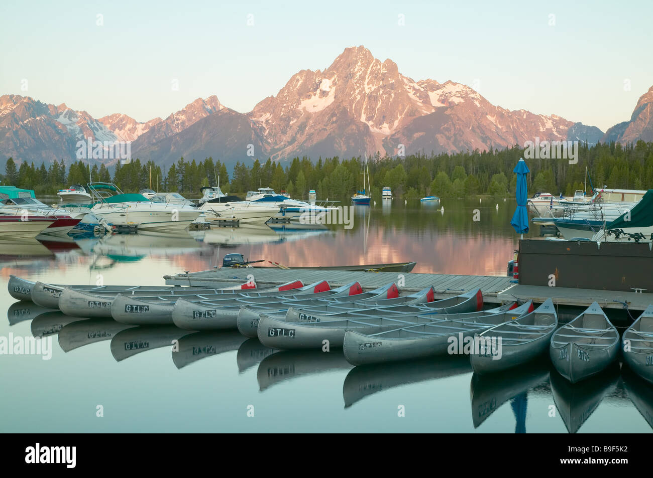 First light after sunrise paints Mount Moran and the surface of Jackson ...