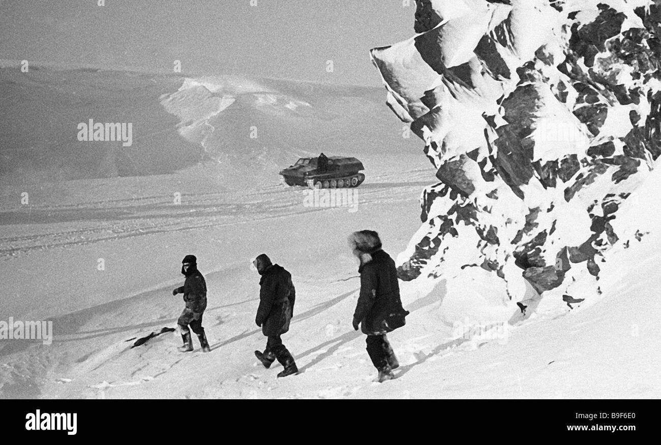 Polar explorers waiting for cross country vehicle on Cape Chelyuskin ...