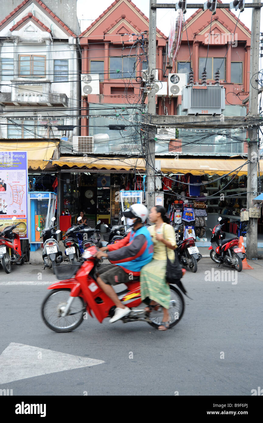 Thai riders on a moped on the walking street, Patong Beach, Phuket ...