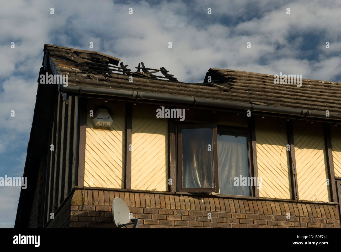 Burnt and collapsed roof of end terraced house following bedroom and ...