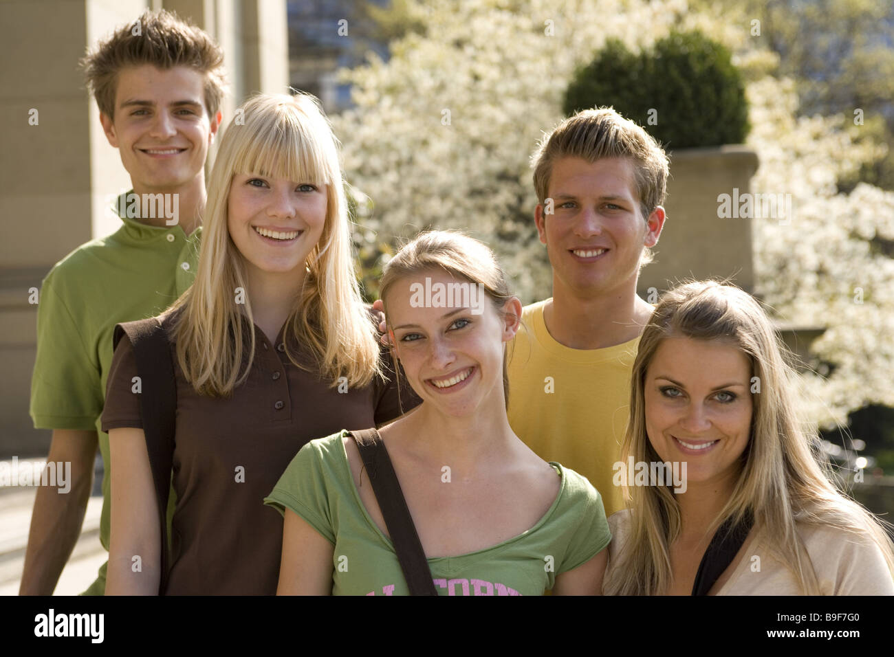 University students cheerfully group-picture outside series people ...