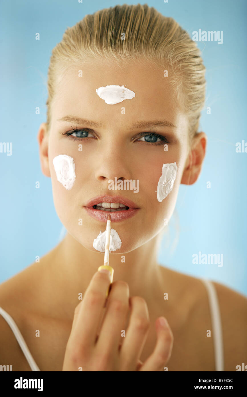 Woman young face puts cream lips makes up portrait series people Top ...