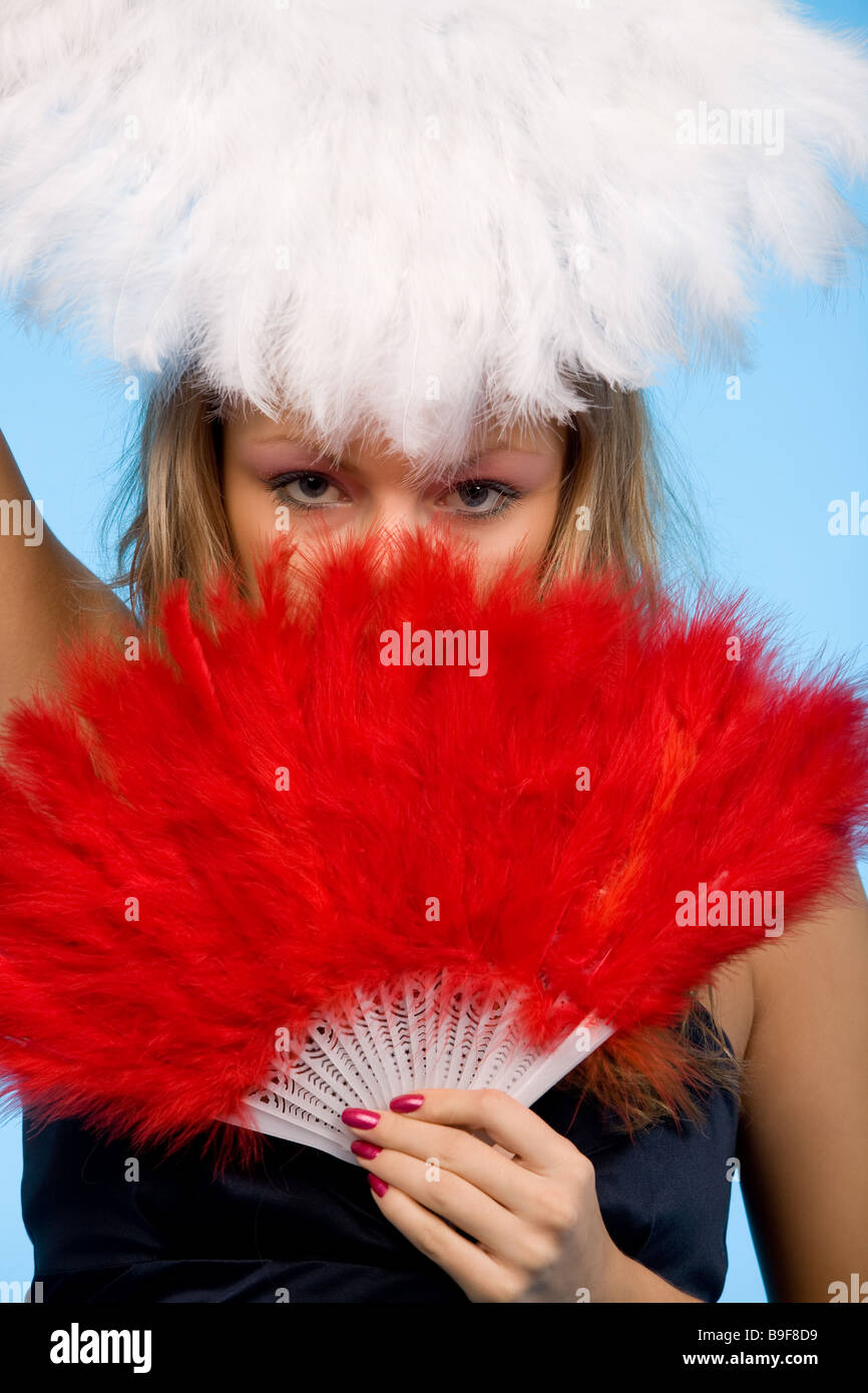 beautiful woman with two fans on a blue background Stock Photo - Alamy