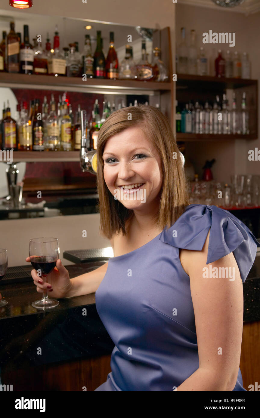 Young Woman having a drink at a bar Stock Photo - Alamy