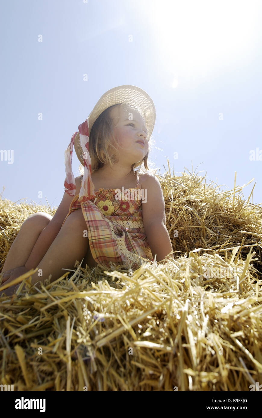 Child girl straw sitting Stock Photo - Alamy